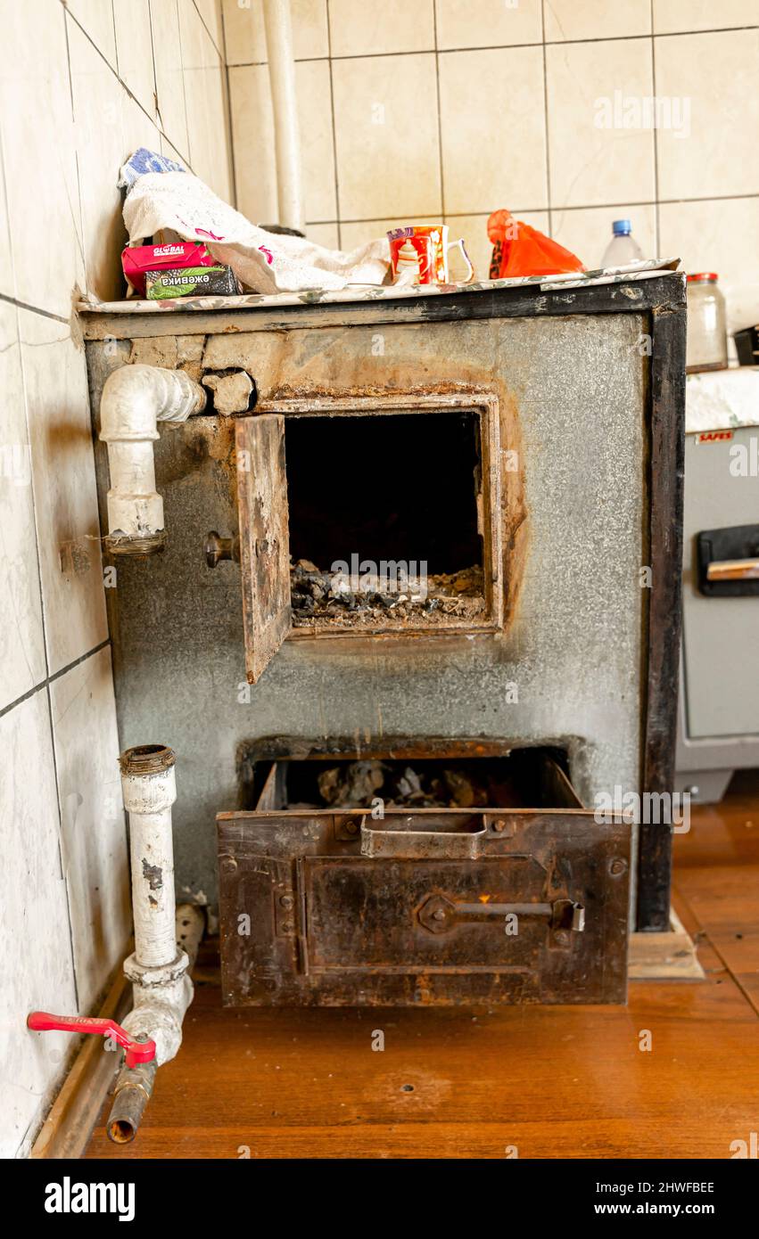 Old rusty oven heat by fire, with a compartment drawer filled with ash ...
