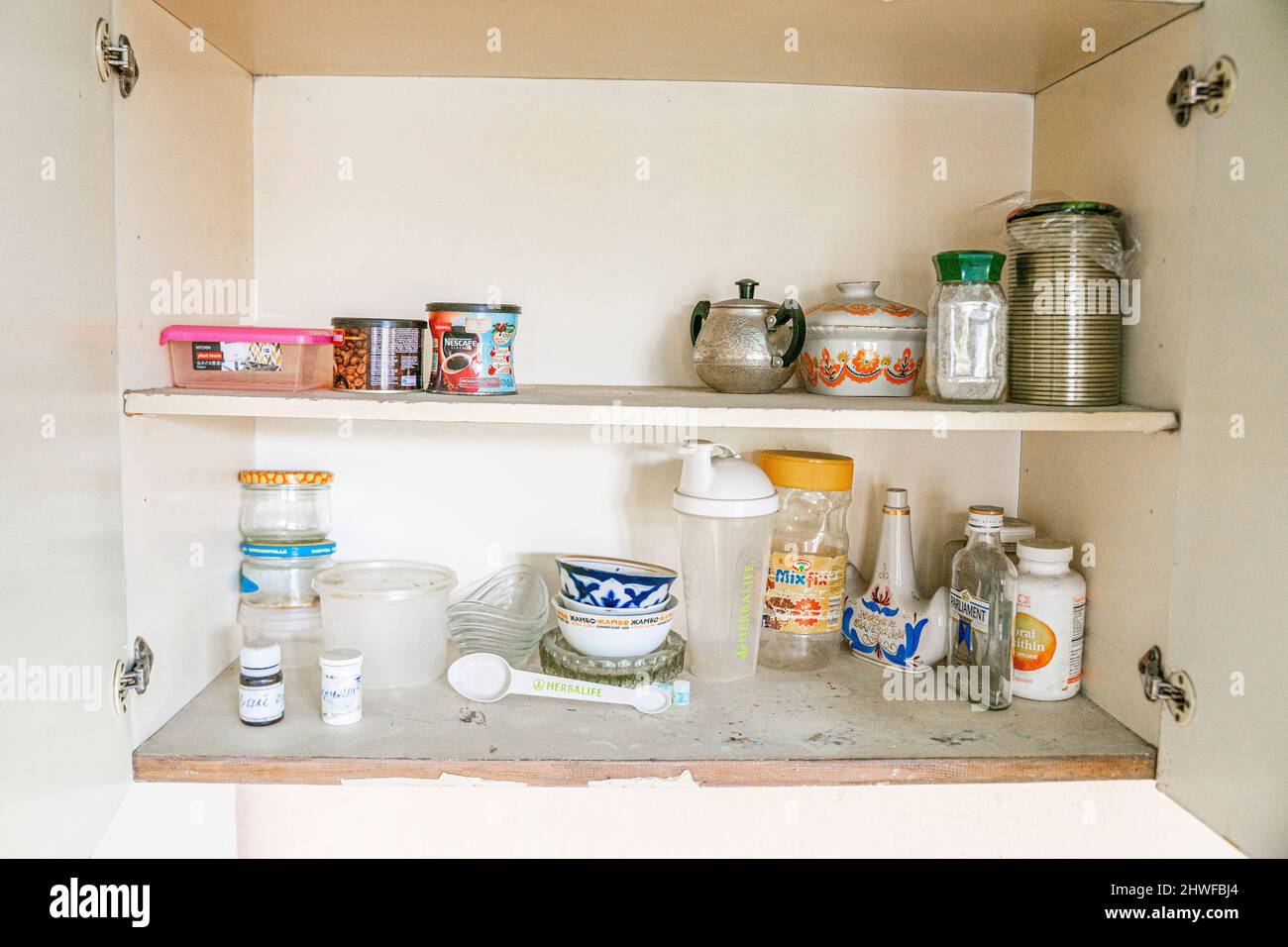 Jars cans assorted on the shelves of a typical Soviet Russian cupboard ...