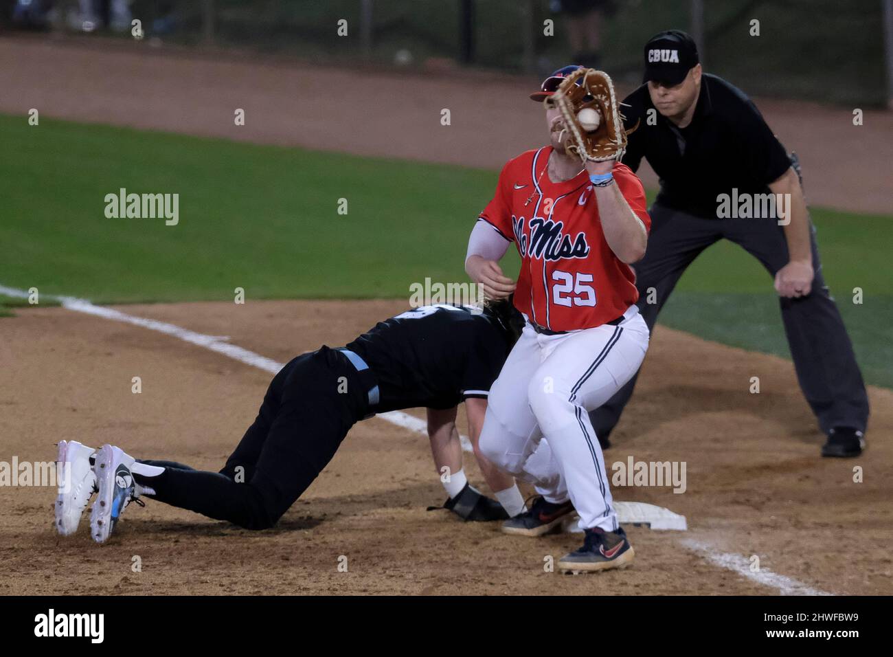 MARCH 05, 2022: Ole Miss First Baseman Tim Elko (#25) catches a ball at ...