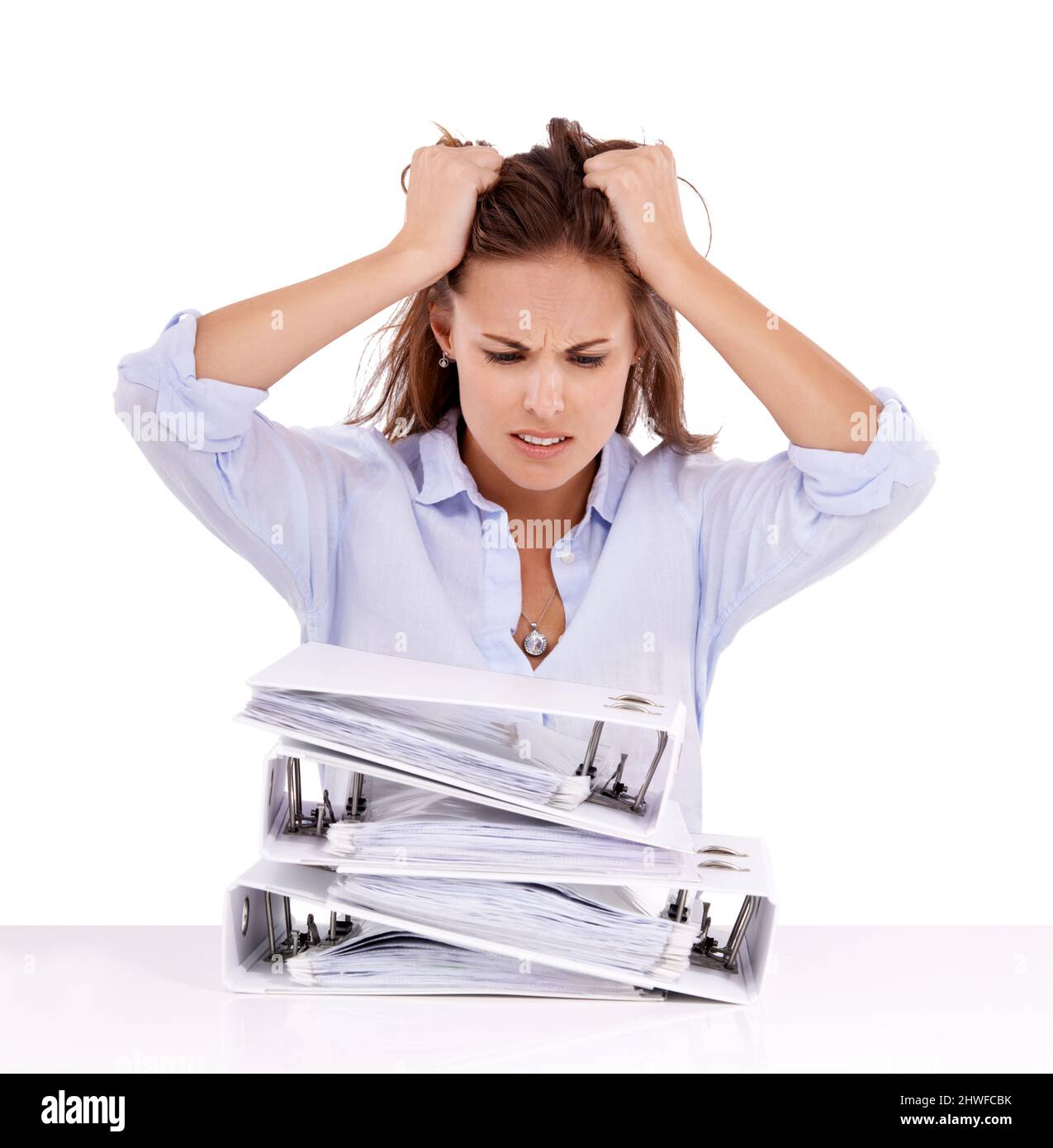 Aargh Ill never get through all this. Frustrated businesswoman with a ...