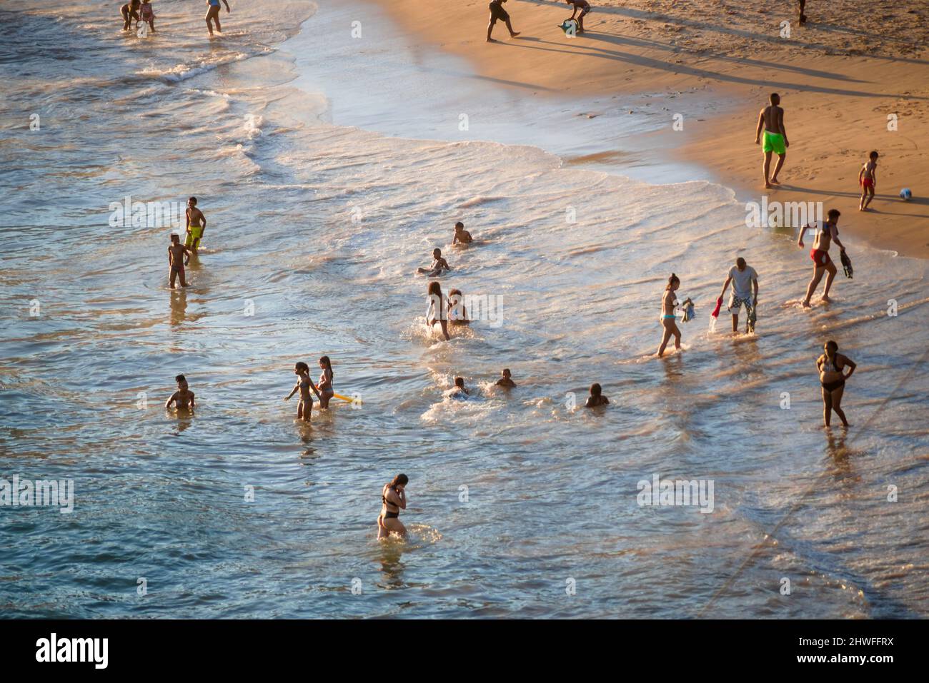 Large group of people on the beach in a bright sunny day in the city of ...