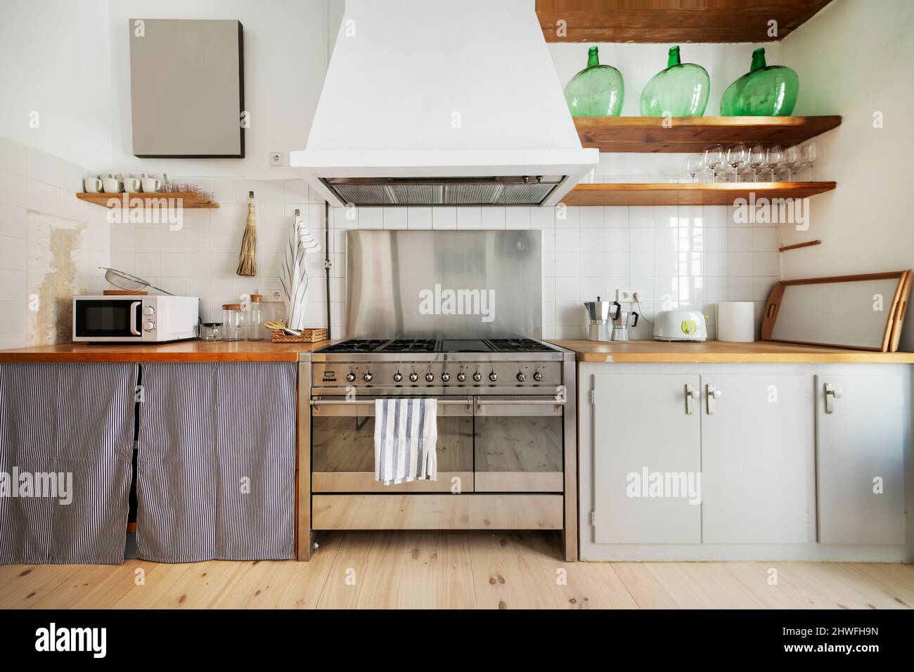 beautiful built-in kitchen with wooden worktop, gas stove with ovens ...