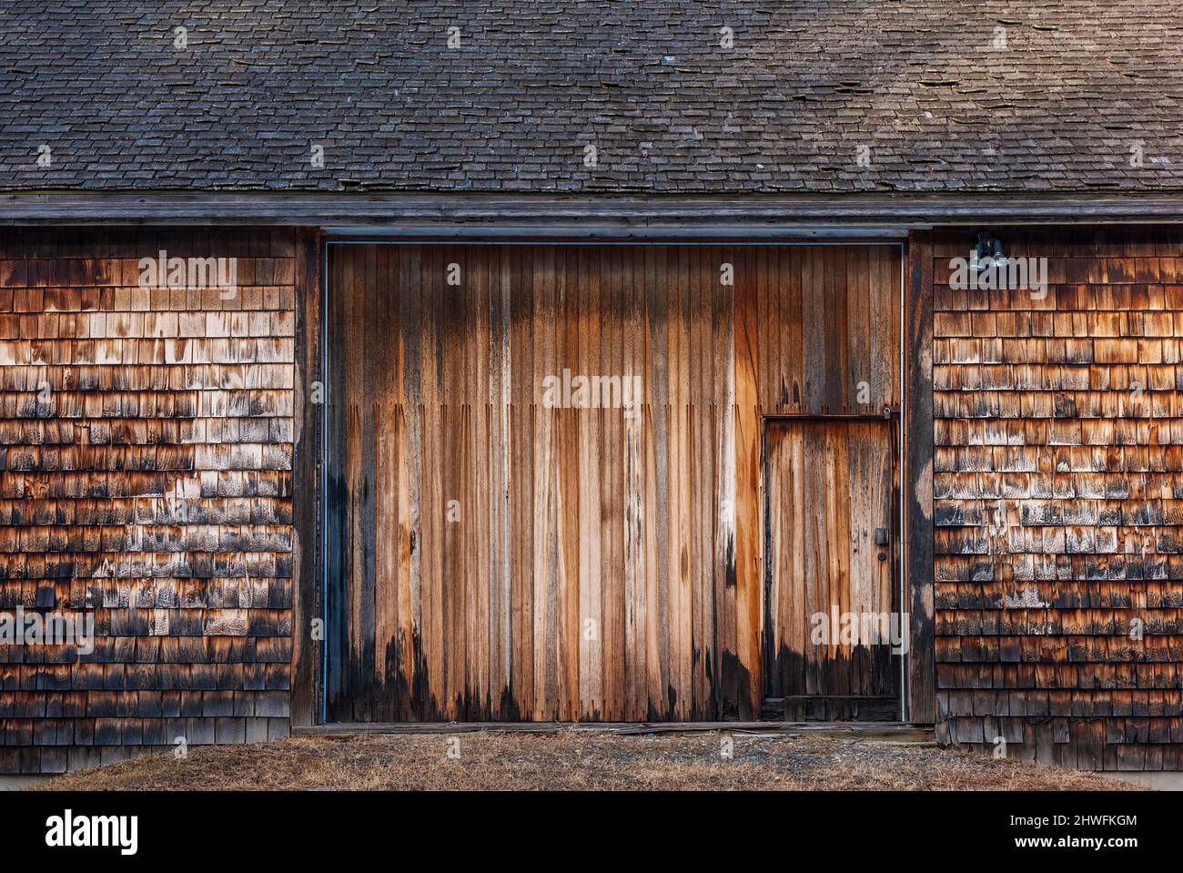 Details of a rustic farmstead barn. Roofing, siding and barn doors with ...