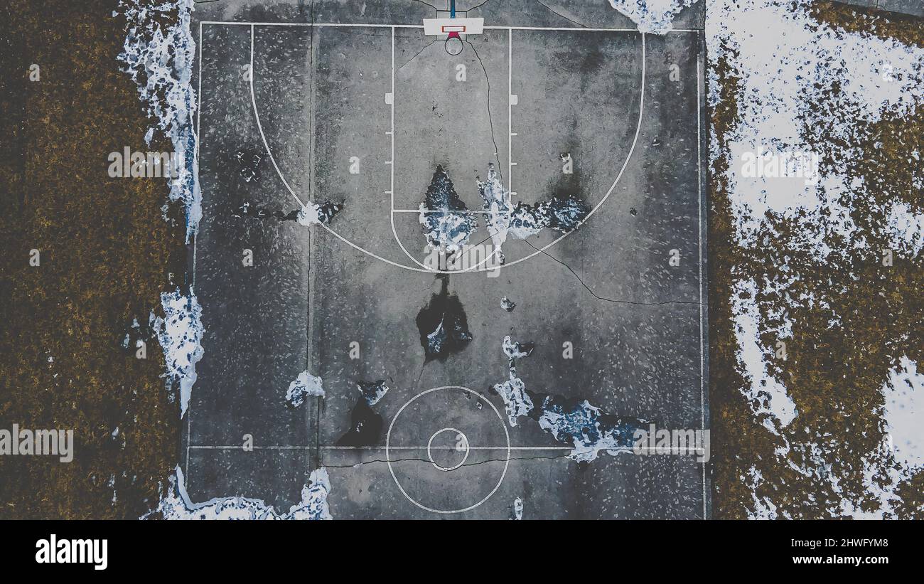 Snow is beginning to melt exposing the basketball court Stock Photo - Alamy