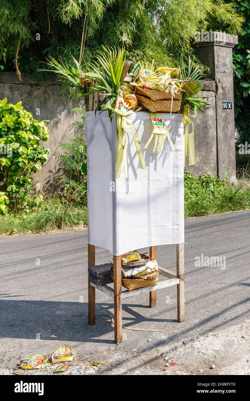 Traditional Balinese offerings for Nyepi celebration on the road along ...