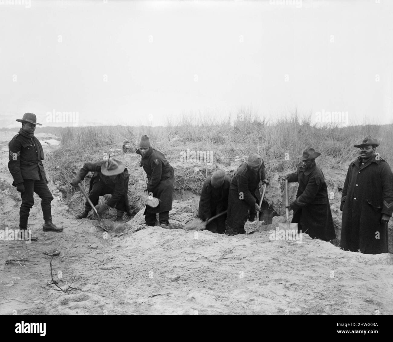 Troops of South African Native Labour Corps digging sand in a camp at ...