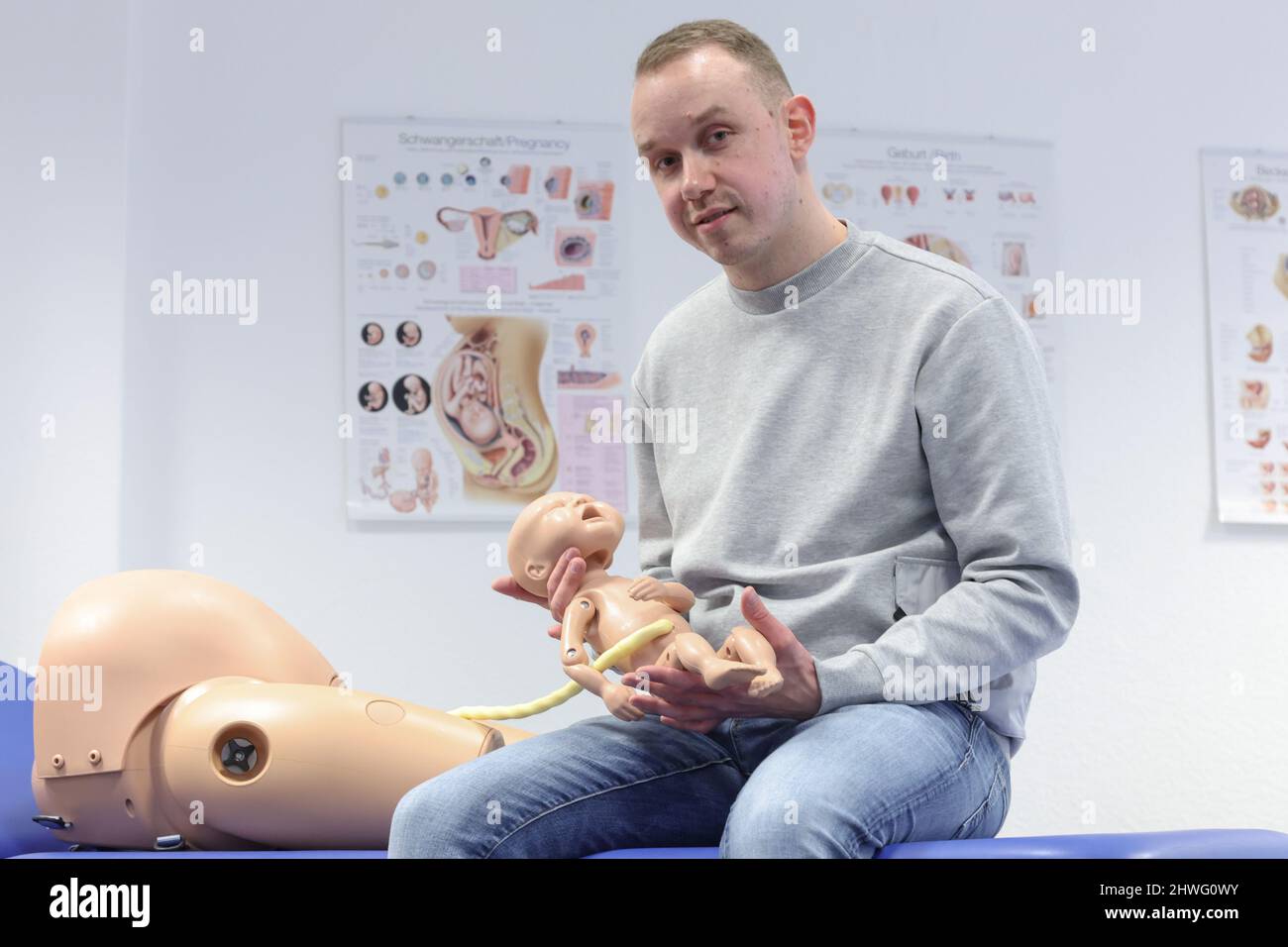 Bielefeld, Germany. 23rd Feb, 2022. Jonas Küppers, male midwife, holds ...