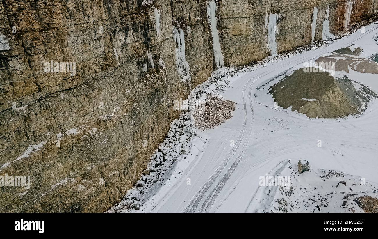 Ice and snow formations on the walls of a quarry. The snow melts on the ...