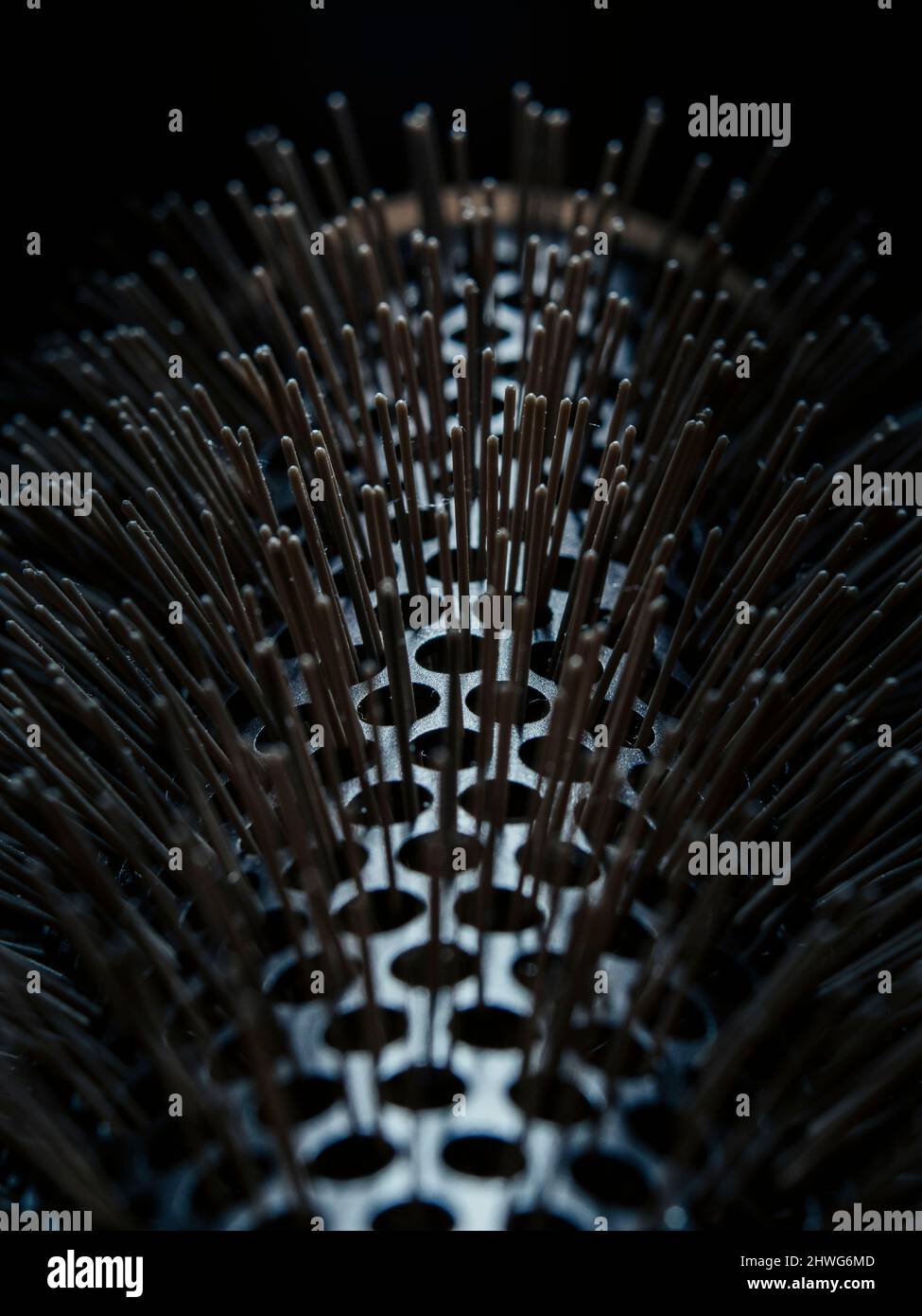 Close up of hairbrush bristles poking out of holes Stock Photo - Alamy