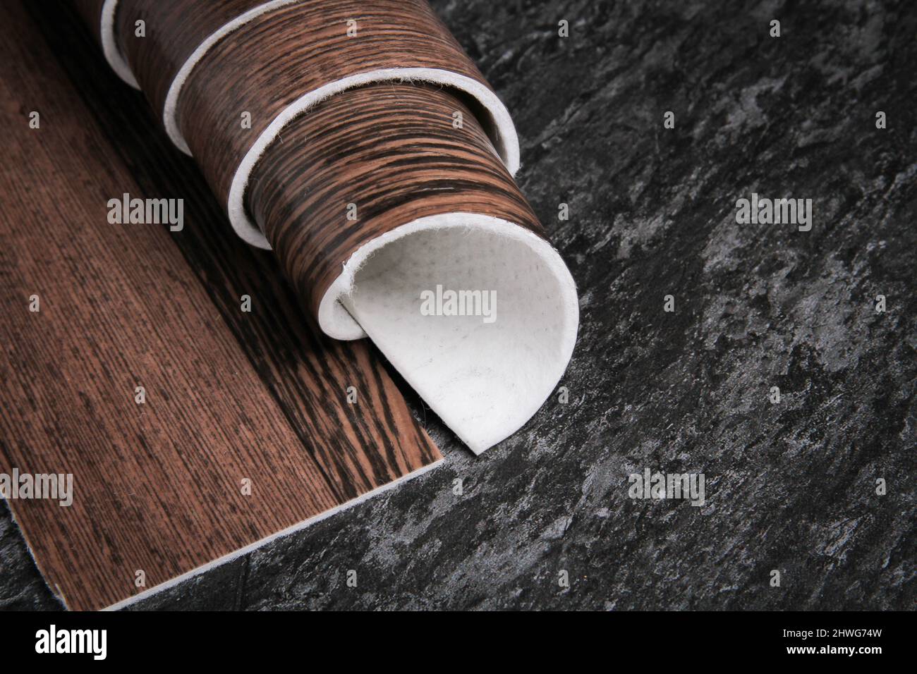 Linoleum. Roll of linoleum on a black background. Floor coverings ...