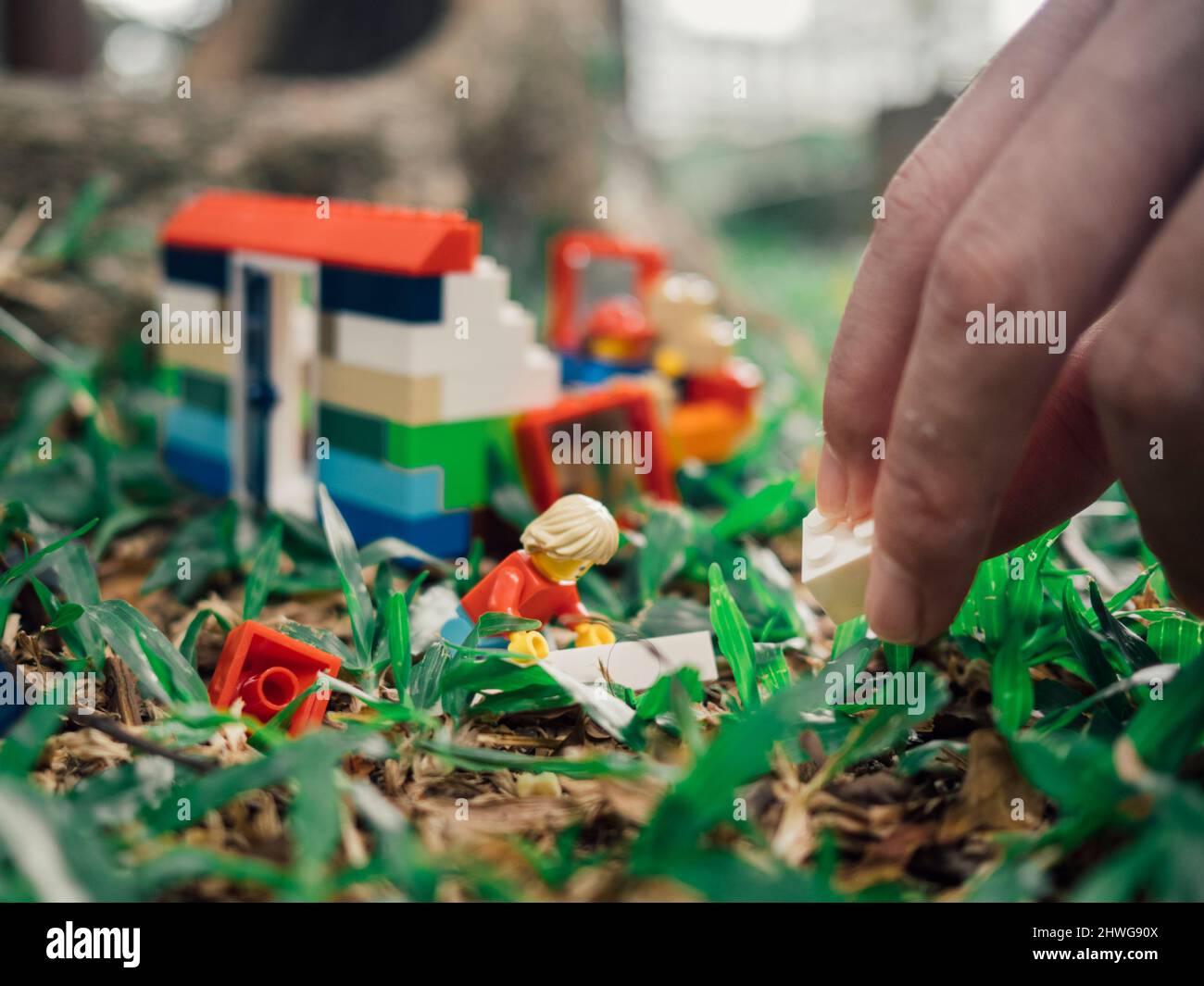 Lego brick and hand hi-res stock photography and images - Alamy