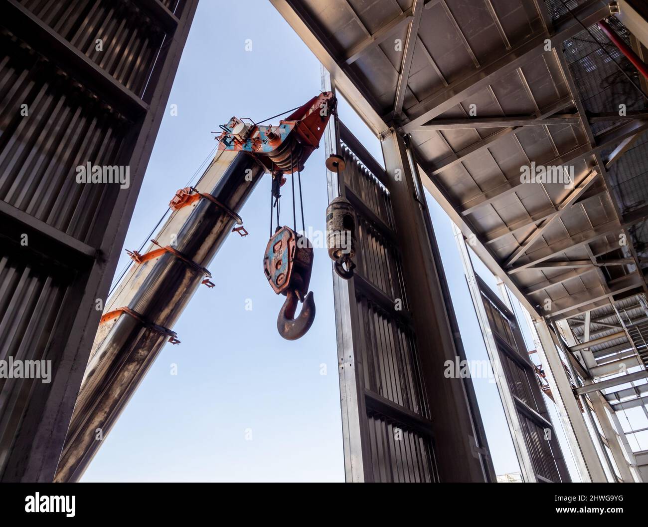 Hoist of crane at the window of industrial plant Stock Photo - Alamy