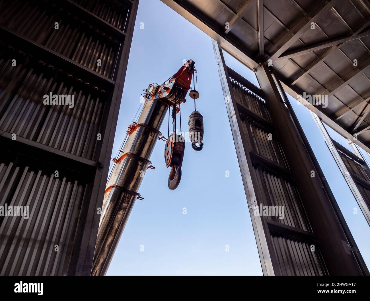 Hoist of crane at the window of industrial plant Stock Photo - Alamy