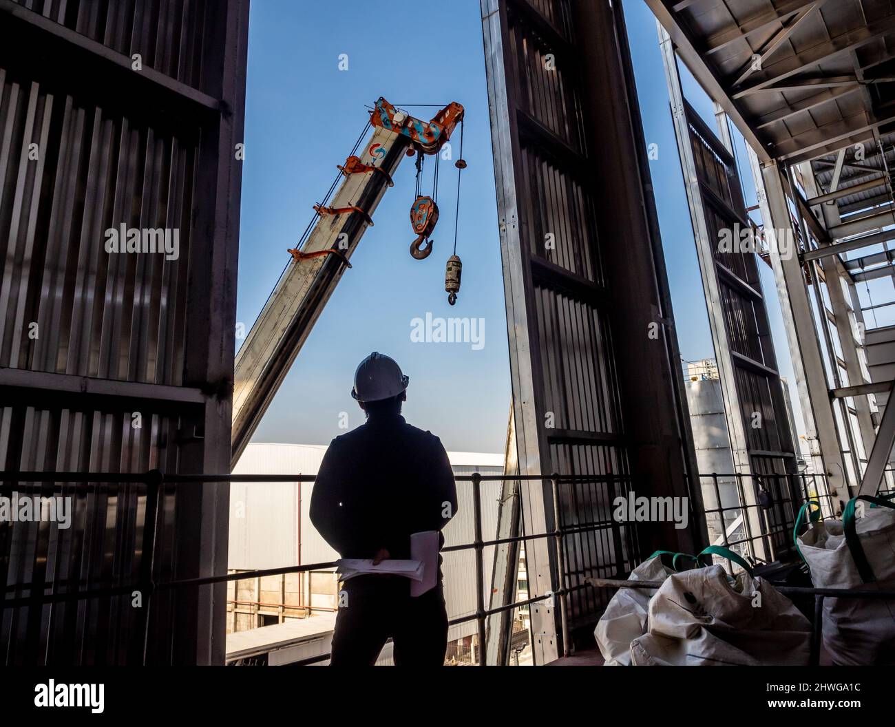 Hoist of crane at the window of industrial plant Stock Photo - Alamy
