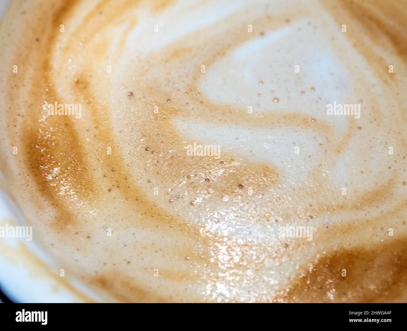 Full-frame close-up texture surface of soft and delicate milk froth in ...