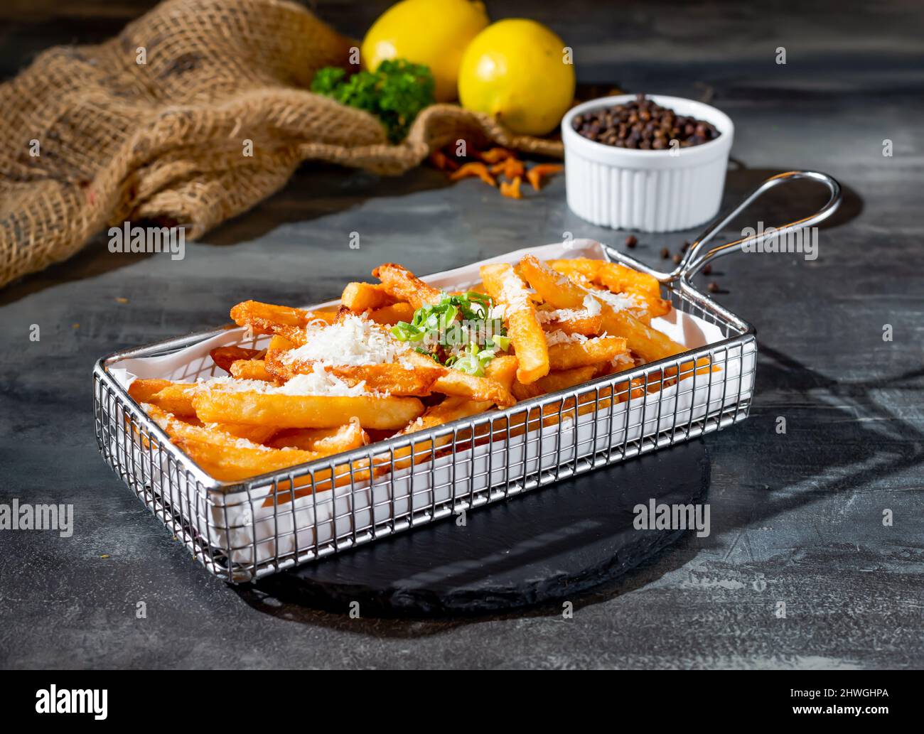 Truffle Fries in deep fryer dish side view on dark background fast food ...