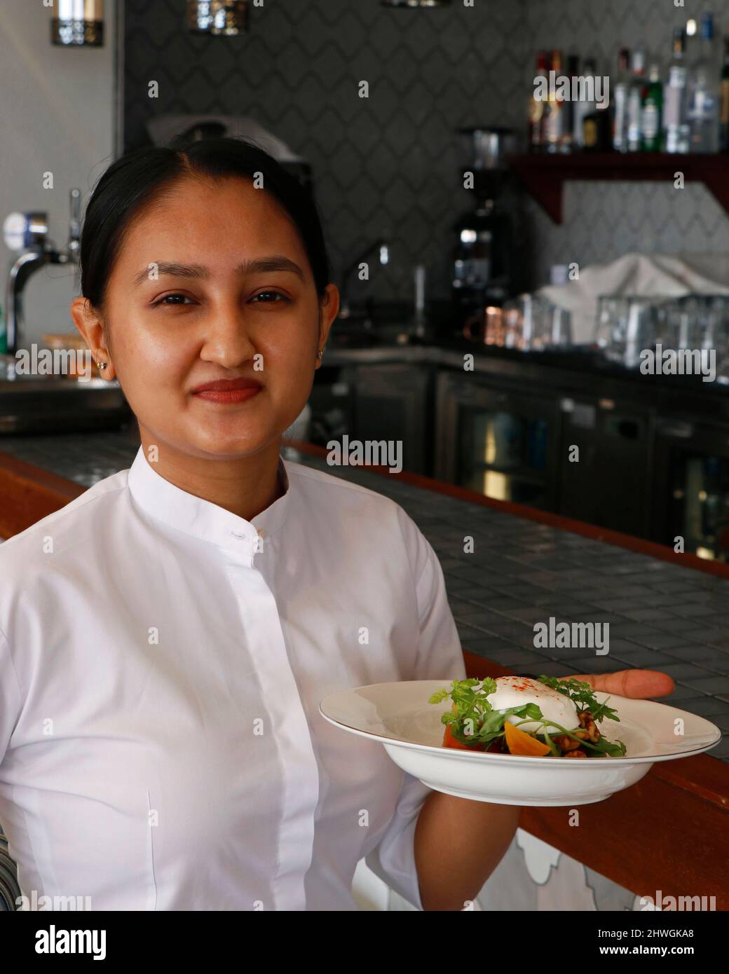 beautiful indian asian waitress girl with food on hand, professional ...