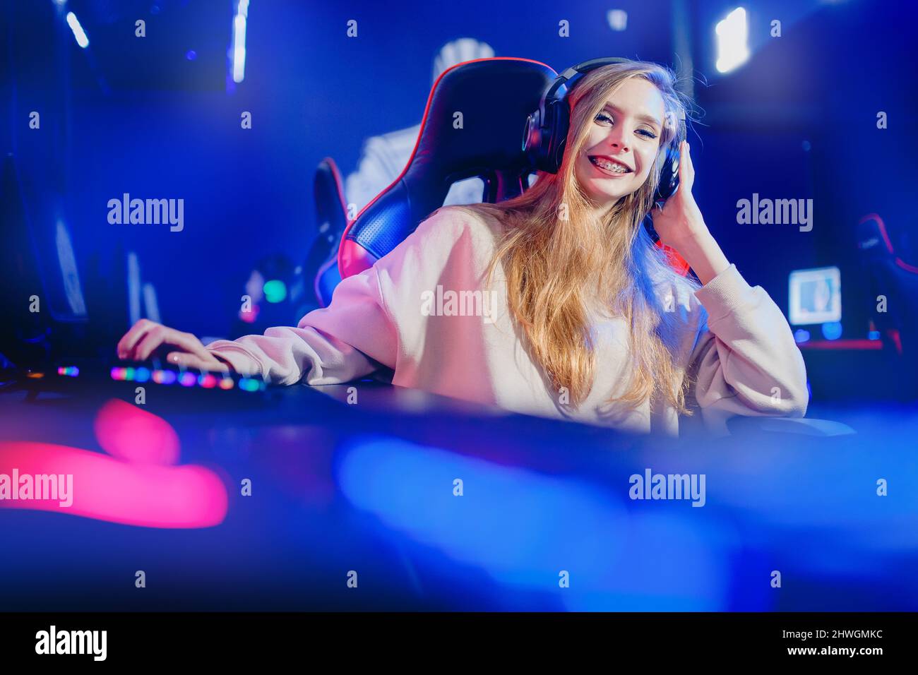Professional cyber video gamer woman in studio room with personal ...