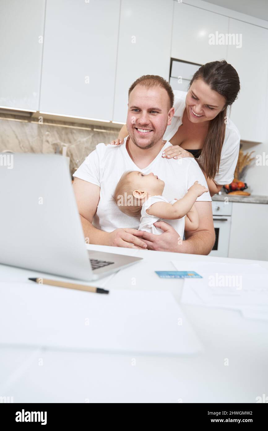 Baby in man hands exchanging looks with its mother Stock Photo - Alamy