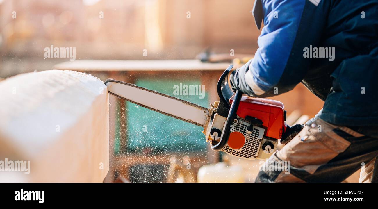Worker carpenter builder working on roof house of log structure ...