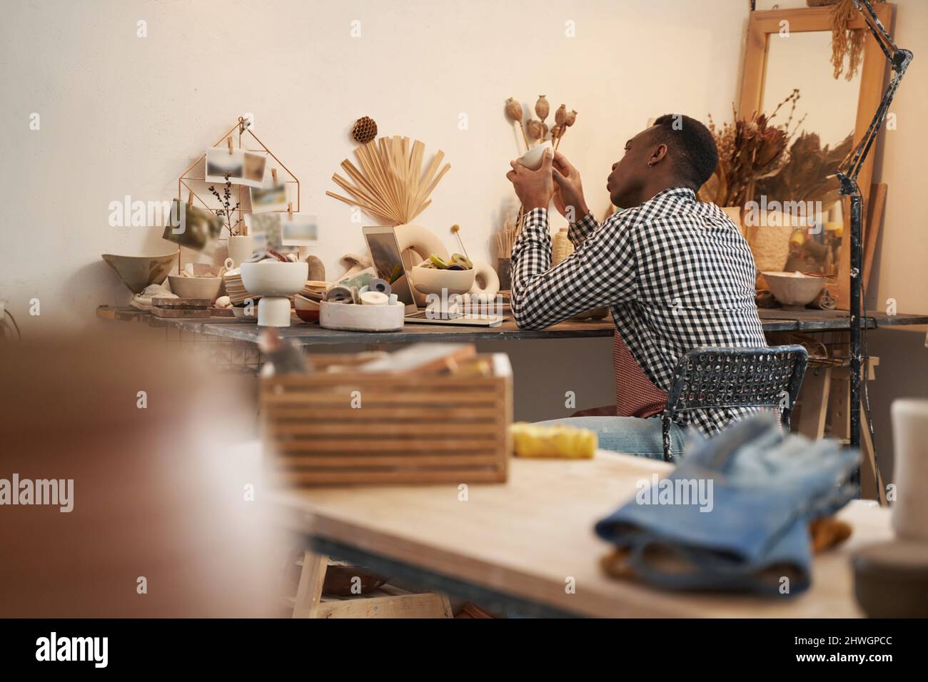 Concentrated potter checking surface texture of pottery product Stock ...