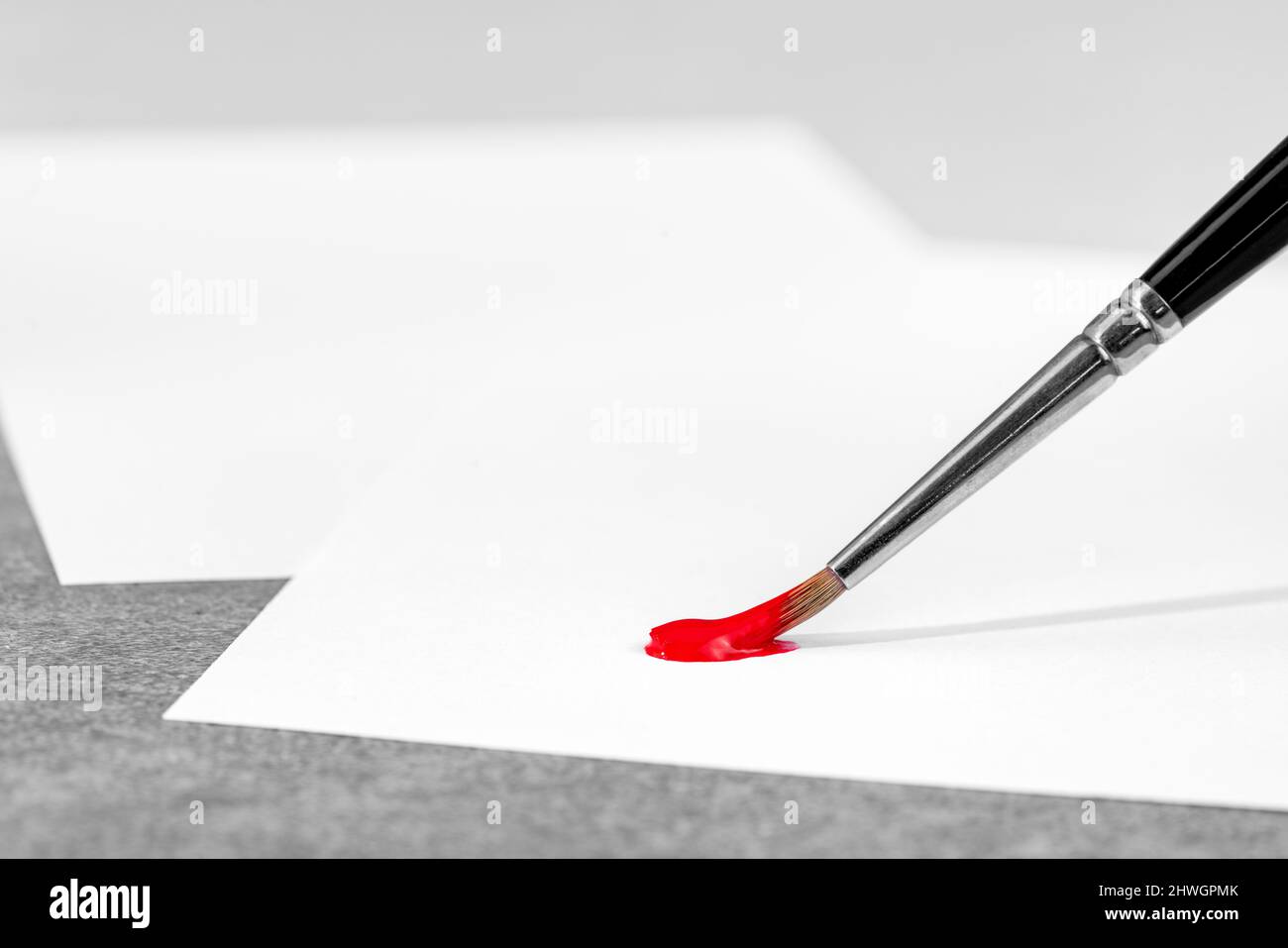 Art and craft theme showing a paintbrush tip with red paint on white ...