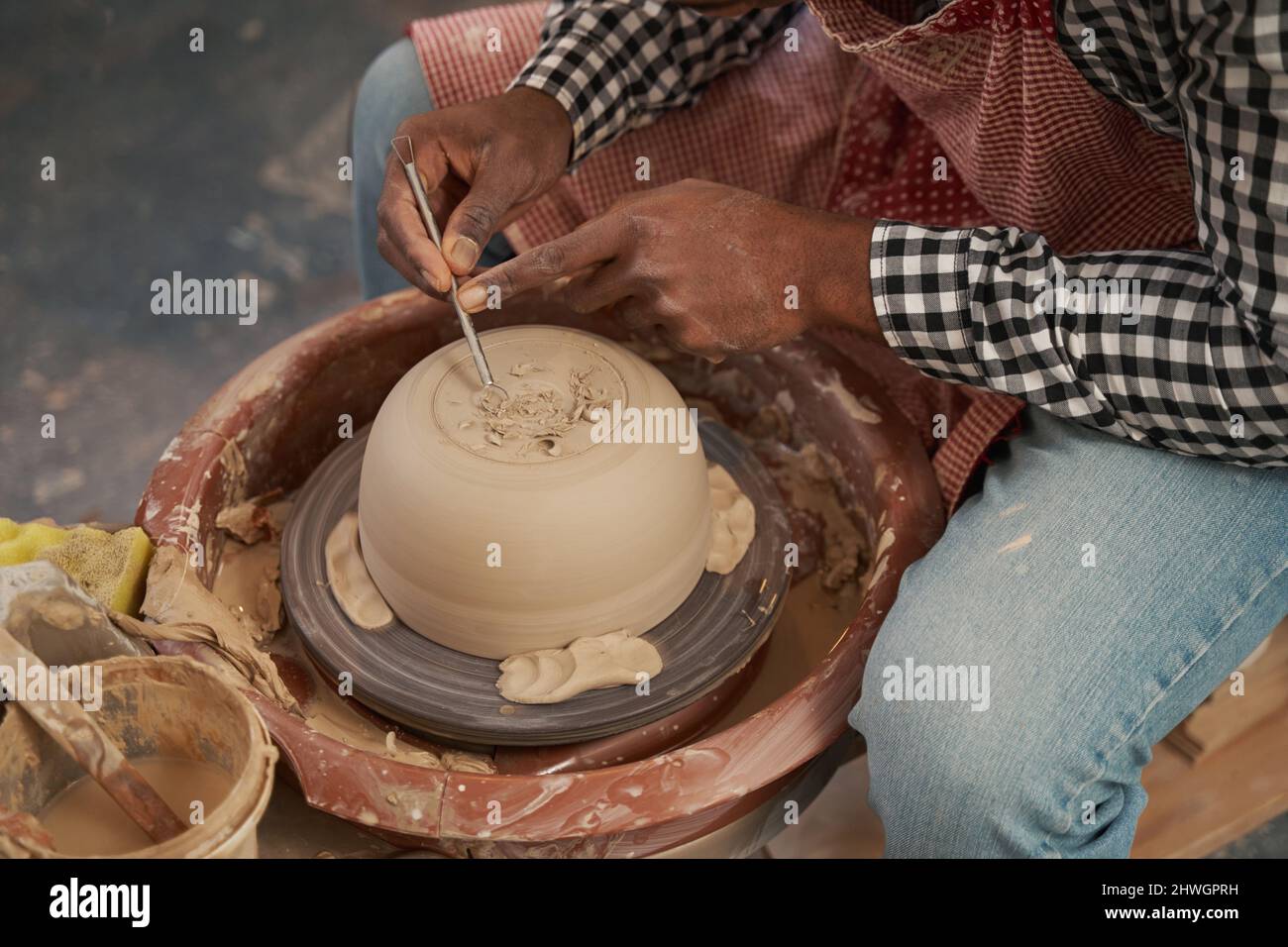 Experienced potter removing excess clay on lower part of bowl Stock ...