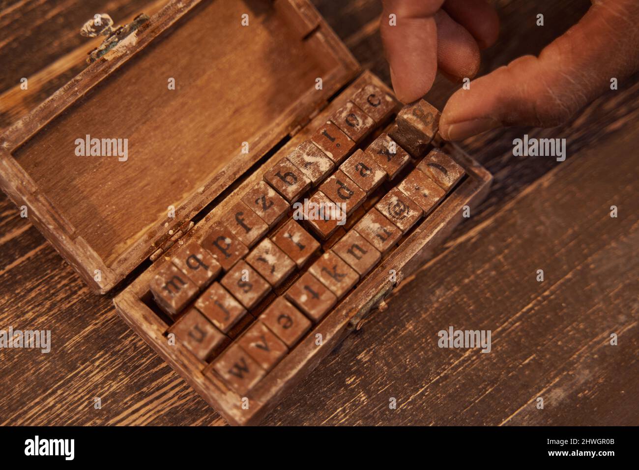 Experienced potter choosing letters for marking pottery Stock Photo - Alamy