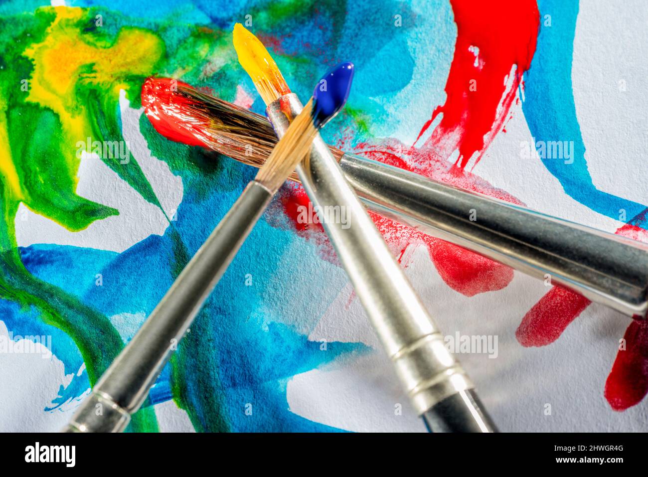 Art and craft theme showing some crossed paintbrush over colorful ...