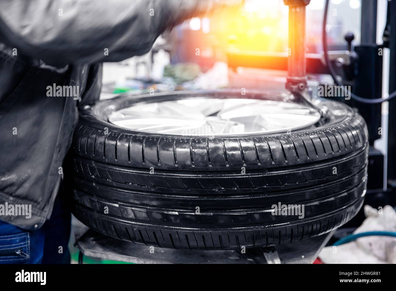 Mechanic changing wheel, replacement of winter and summer tires of ...