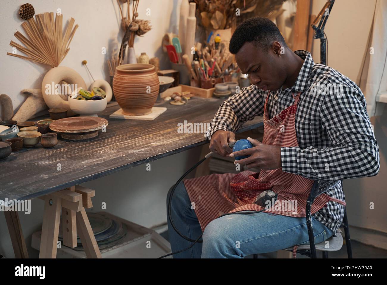 Concentrated potter smoothing out exterior pottery surface Stock Photo ...