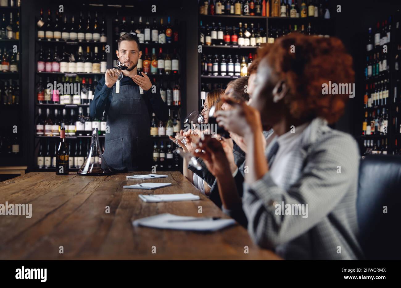 Tasting red wine Professional sommeliers man and woman and taking notes ...