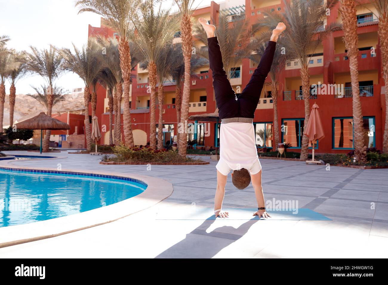 Handstand asana meditation yoga caucasian man in white shirt on ...