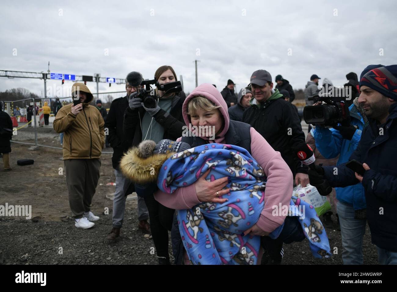 Medyka, Poland - March 5, 2022: a refugee woman brings her child arrive ...