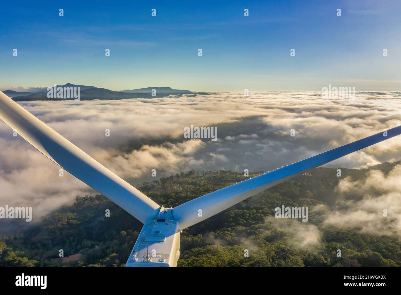 Aerial view of windmill or wind farm in fog at Cau Dat town, Da Lat ...