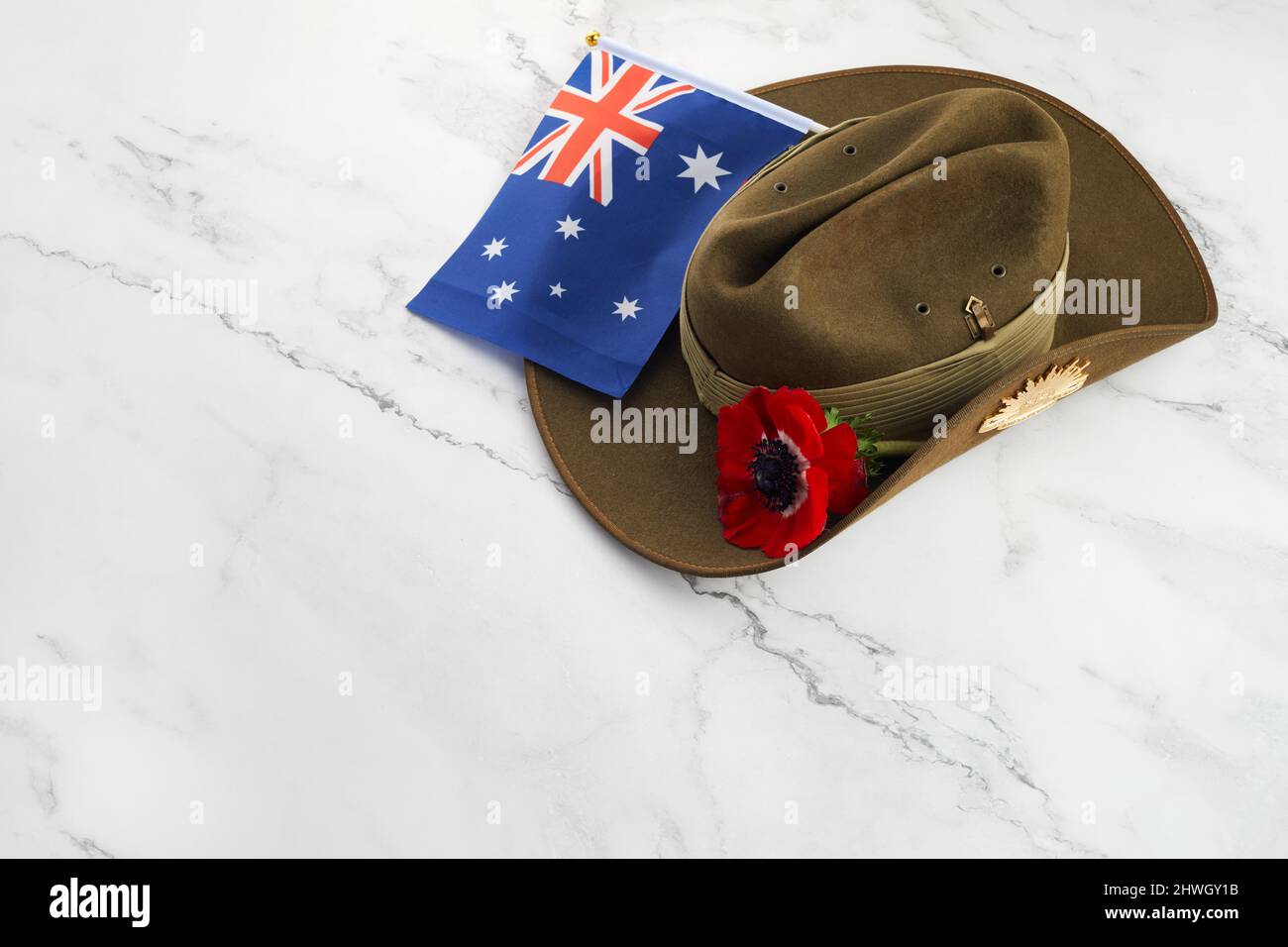Anzac army slouch hat with Australian Flag and Poppy on stone ...