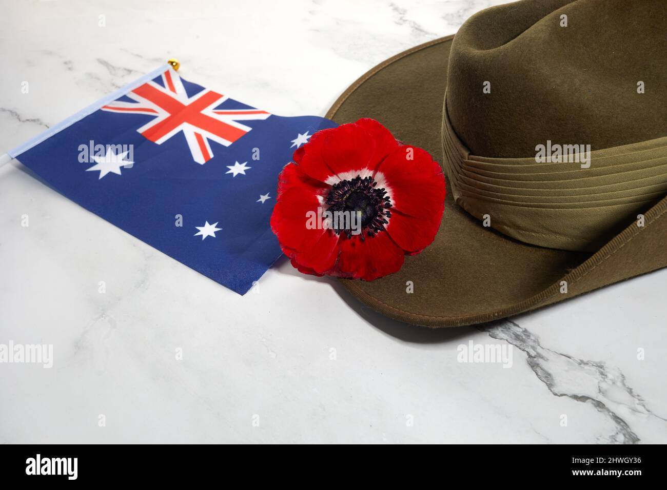 Anzac army slouch hat with Australian Flag and Poppy on stone ...