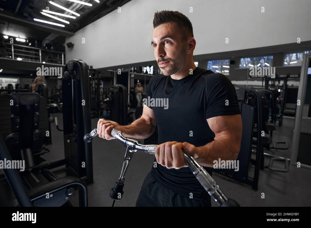 Delighted male person building muscles on arms Stock Photo - Alamy