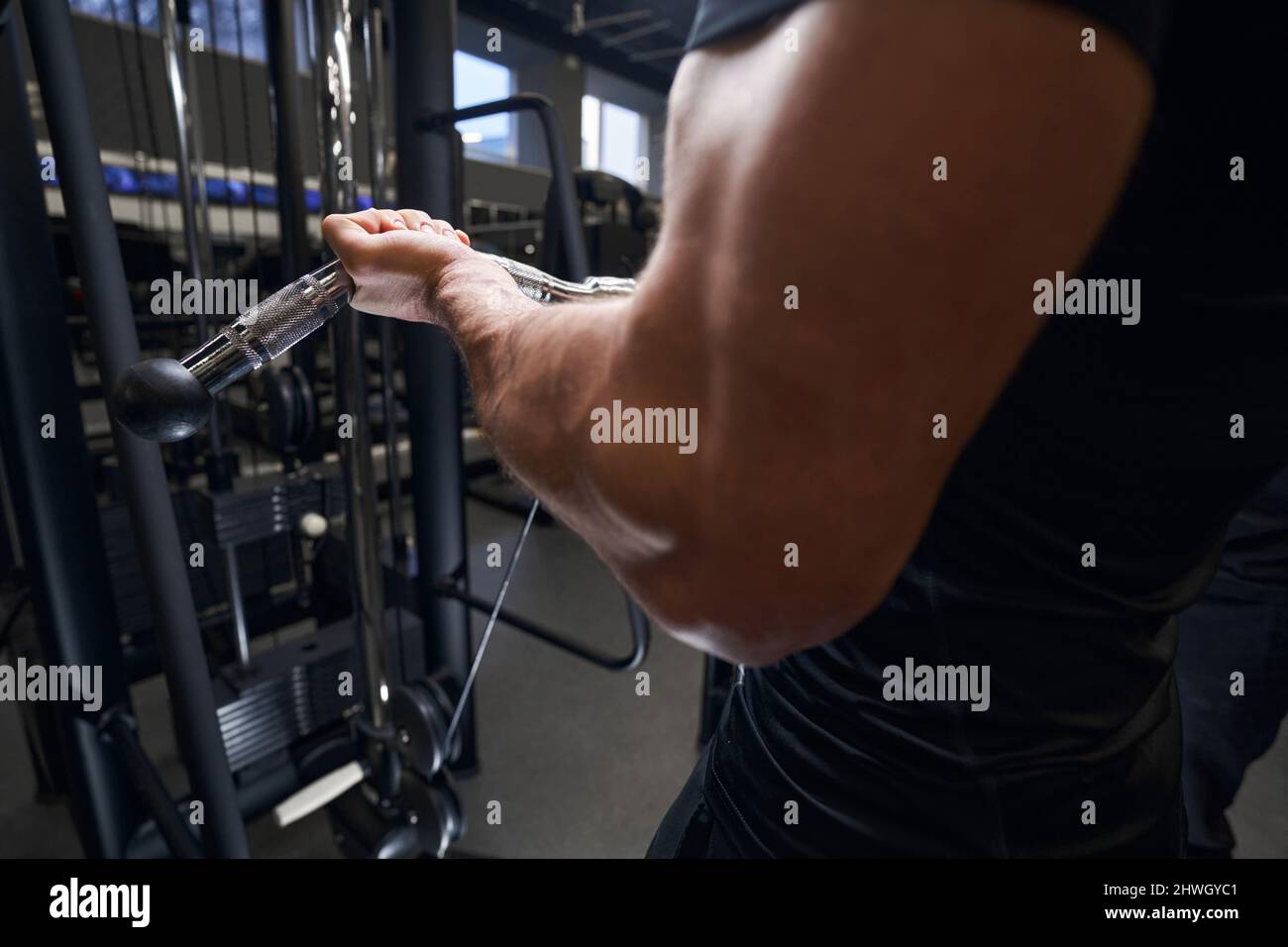 Strong muscular man showing his biceps during training Stock Photo - Alamy