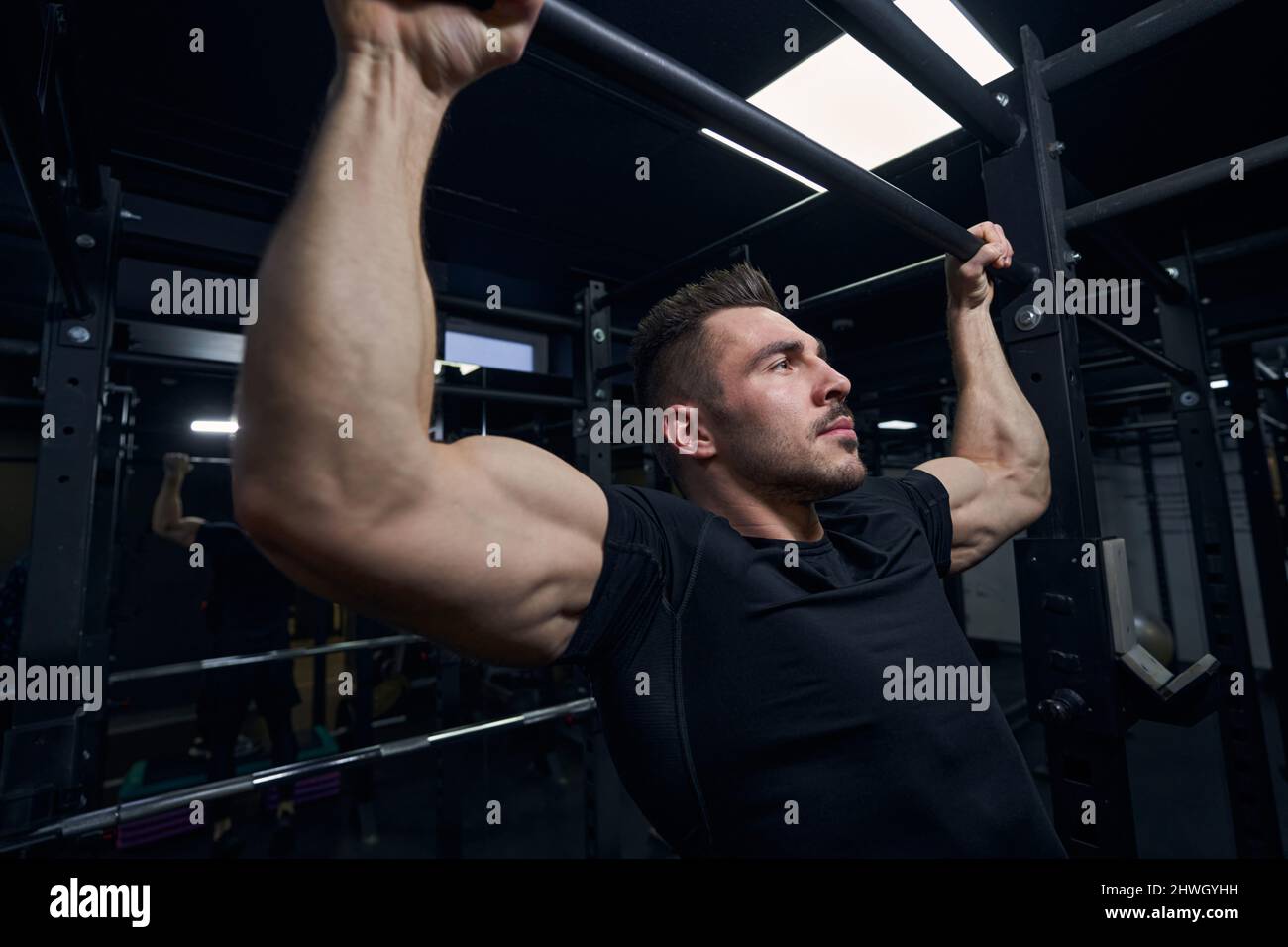 Strong athlete demonstrating power of his muscles Stock Photo - Alamy