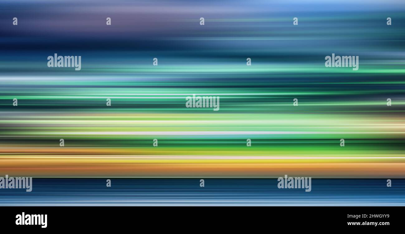 Abstract Rainbow light trails on the dark blue background. Motion blur ...
