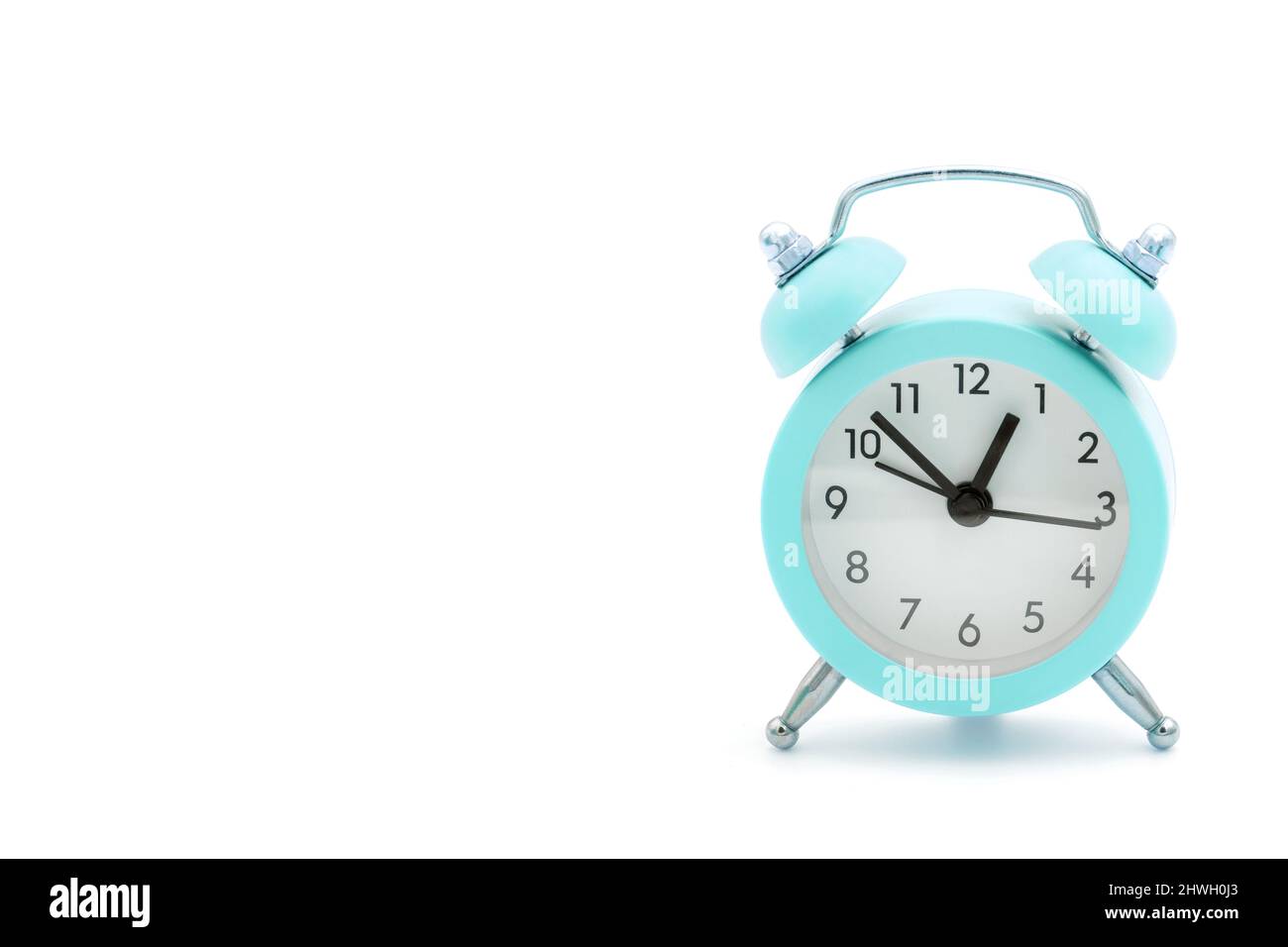 Classic blue table clock on a white background Stock Photo - Alamy