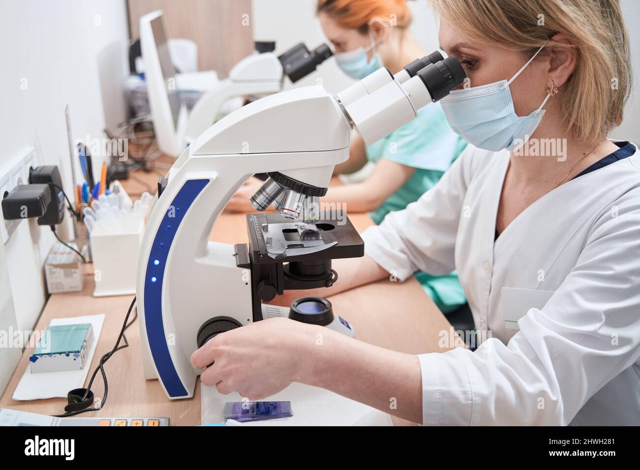 Ladies working in the laboratory with microscopes Stock Photo - Alamy