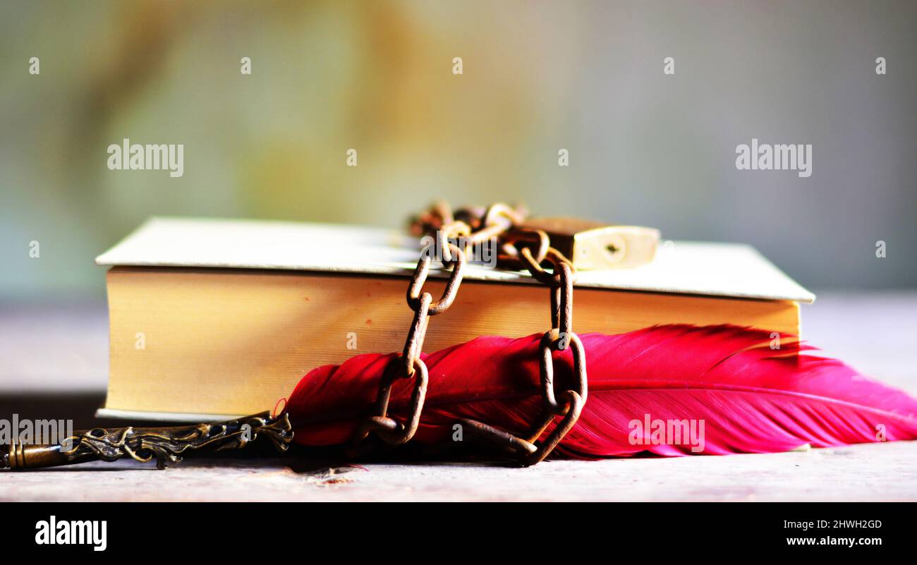 a pen chained to a book Stock Photo - Alamy