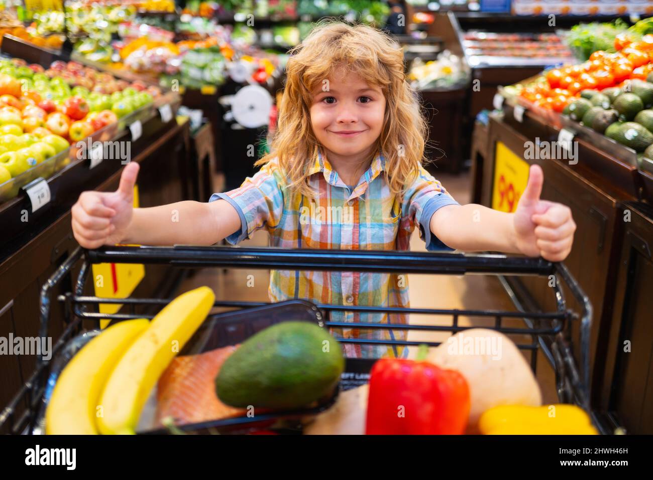 Child buying fruit in supermarket. Kid buy fresh vegetable in grocery ...