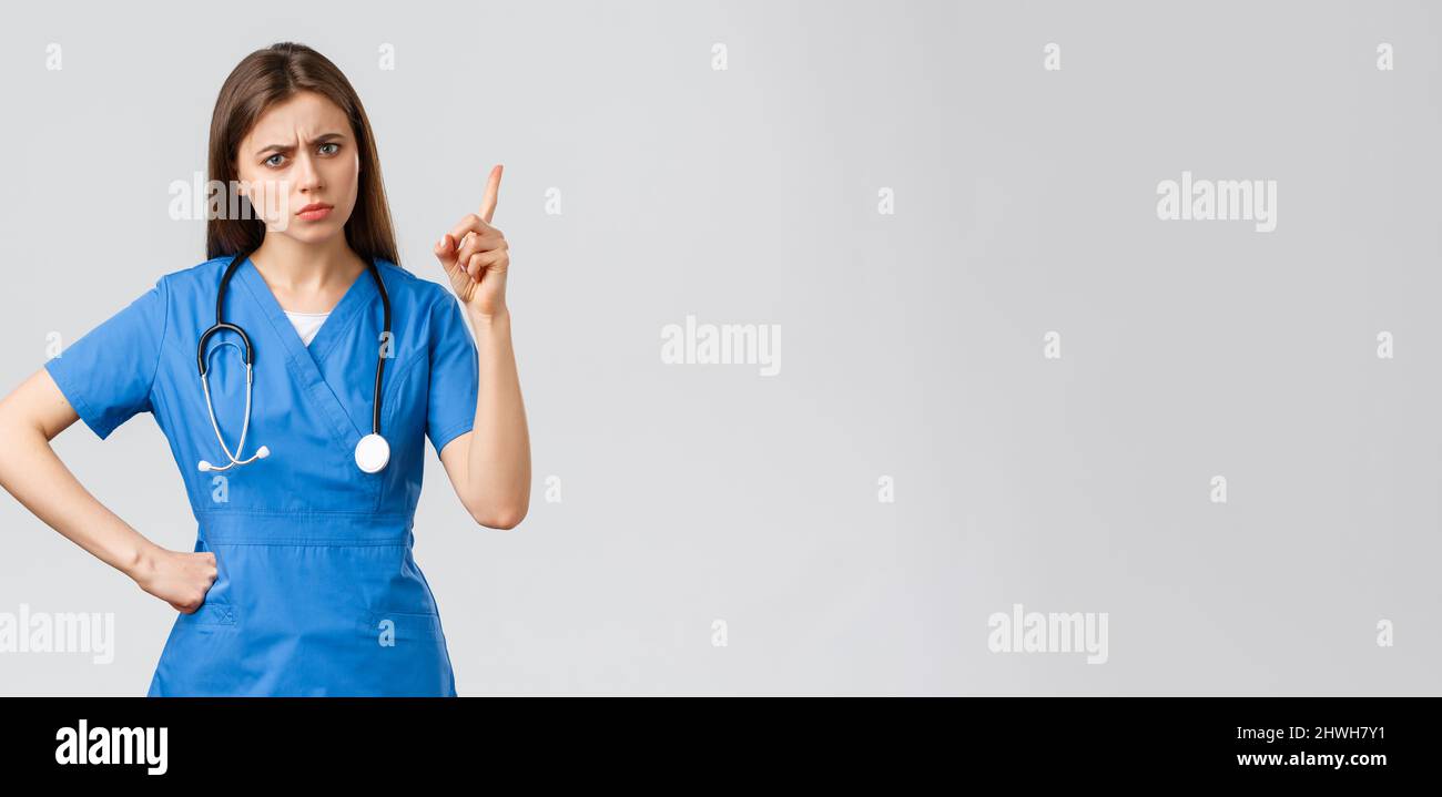 Medical workers, healthcare, covid-19 and vaccination concept. Frowning ...