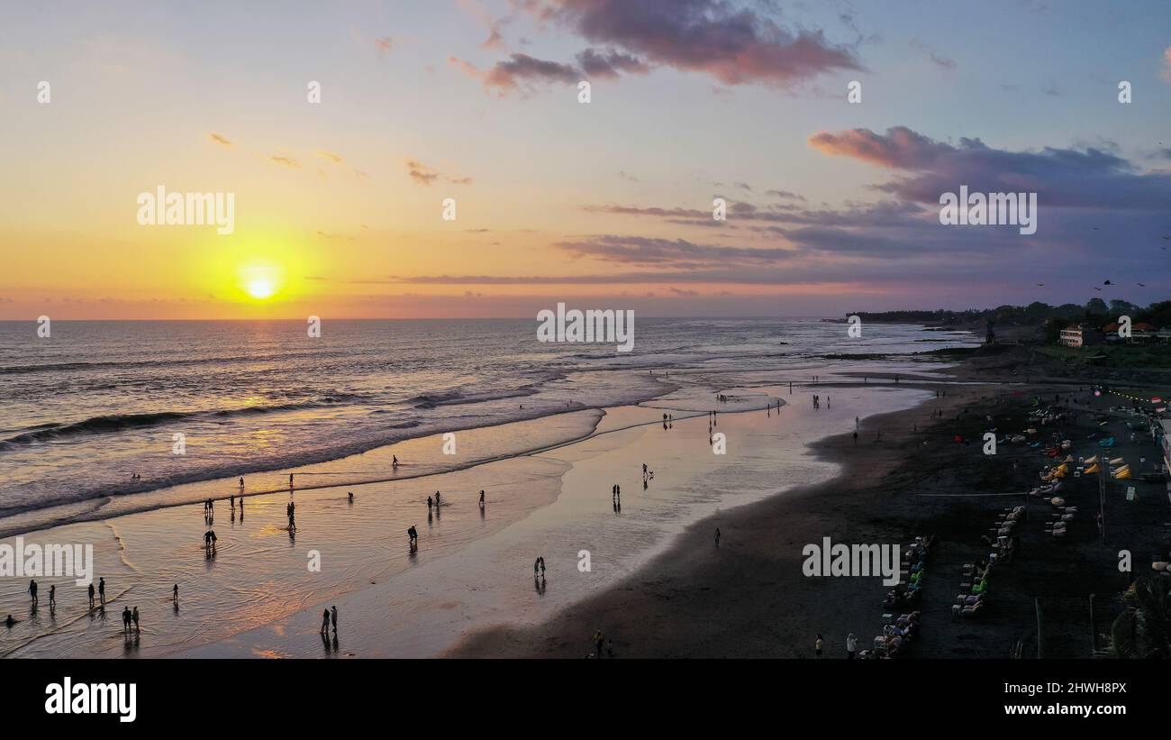 People walk along Echo Beach before sunset. Aerial Shot Of Tourists ...