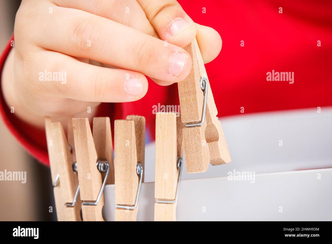 Preschooler playing with wooden clip. Development of kids motor skills ...