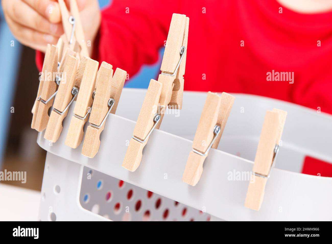 Preschooler playing with wooden clip. Development of kids motor skills ...