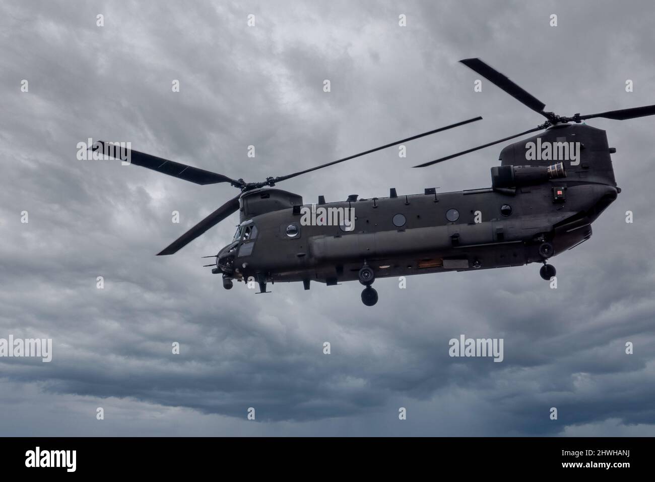 RAF Chinook tandem-rotor CH-47 helicopter flying fast and low in a ...